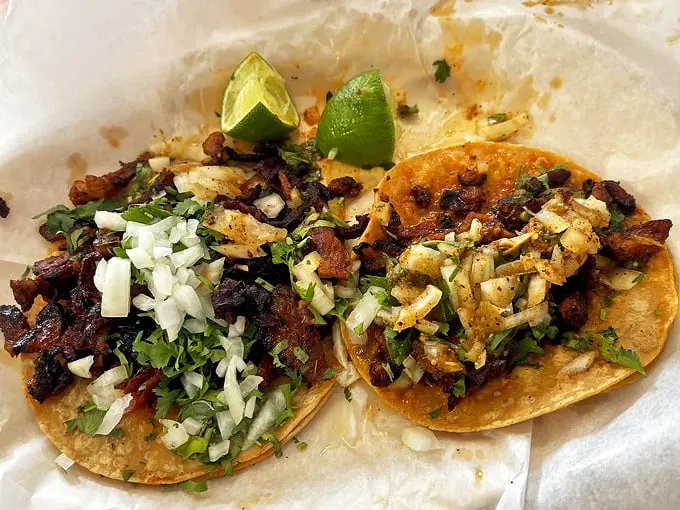These tacos aren't just food—they're edible art. Each one perfectly dressed with fresh cilantro and onions.