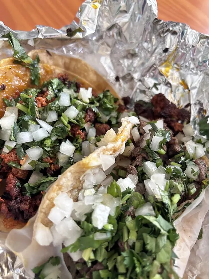 Taco with Chorizo A close-up that could make anyone's mouth water—charred edges, bright lime wedges, and that perfect meat-to-tortilla ratio.