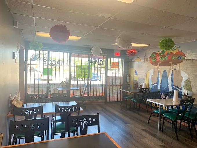 Palm tree cutouts on chairs and colorful murals create an atmosphere that's both welcoming and Instagram-worthy.