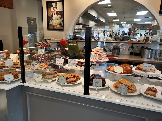 A glass case full of dreams—each pastry competing for your attention like contestants on a delicious reality show.