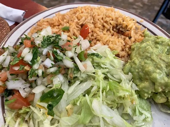 A fiesta of freshness on a plate. This pico de gallo and guacamole combo is so vibrant, it could make a traffic light jealous.