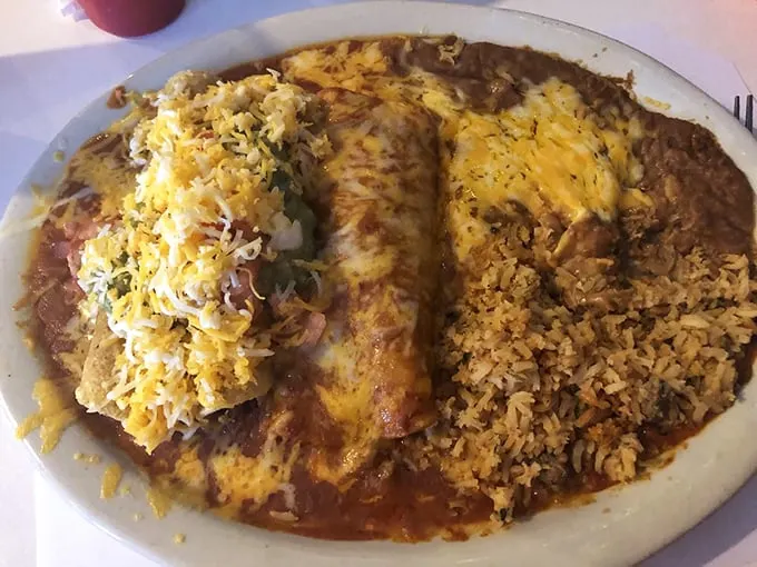 Crunch meets ooze in this Tex-Mex tango. The flautas stand at attention, ready to be devoured, while the enchilada lounges in a pool of savory sauce.