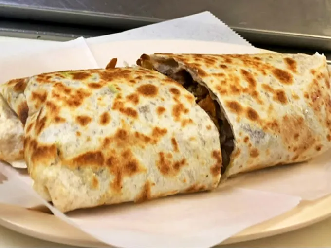 Burrito Behold the burrito—grilled to spotty perfection, it's like a warm, tortilla-wrapped hug waiting to happen.