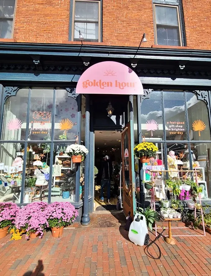 Step into a world of whimsy! Golden Hour Gift Co's charming storefront beckons with vibrant flowers and an eclectic window display that promises treasures within.