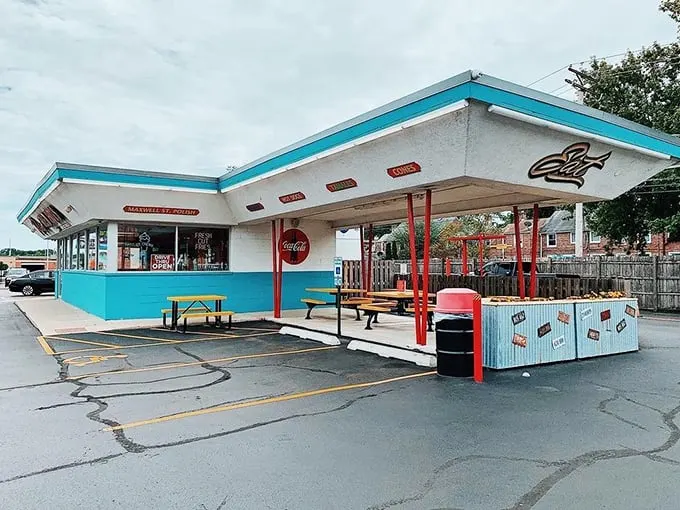 The turquoise and white facade gleams like a perfectly preserved 1950s time capsule, complete with classic drive-in architecture and retro charm.