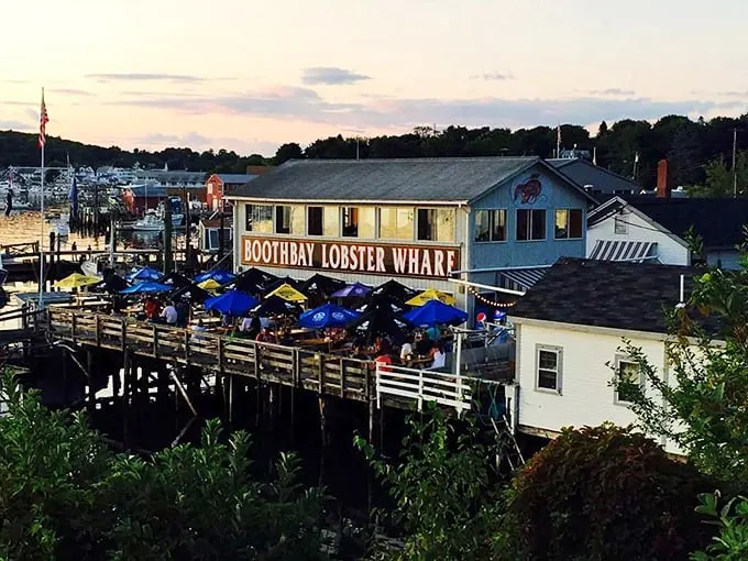 Welcome to lobster paradise! Boothbay Lobster Wharf beckons with its weathered charm and promise of oceanic delights. Those umbrellas? They're not just for show – they're beacons of buttery bliss.