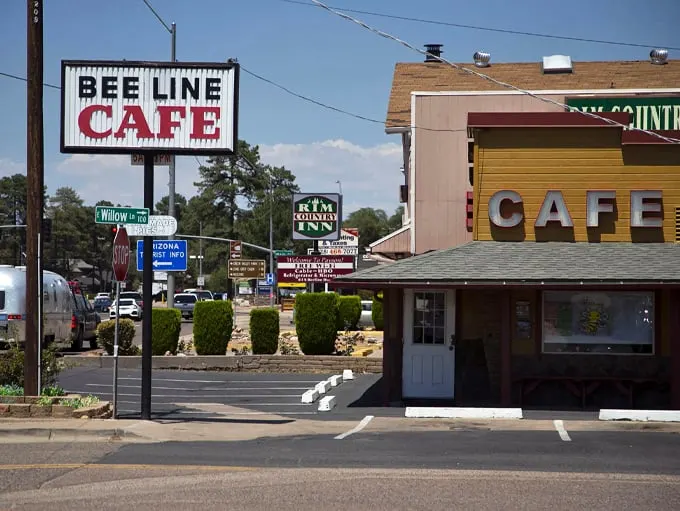 Welcome to flavor town! The Beeline Cafe's retro sign beckons like a neon lighthouse, guiding hungry travelers to a oasis of comfort food. Photo credit: The Arizona Republic