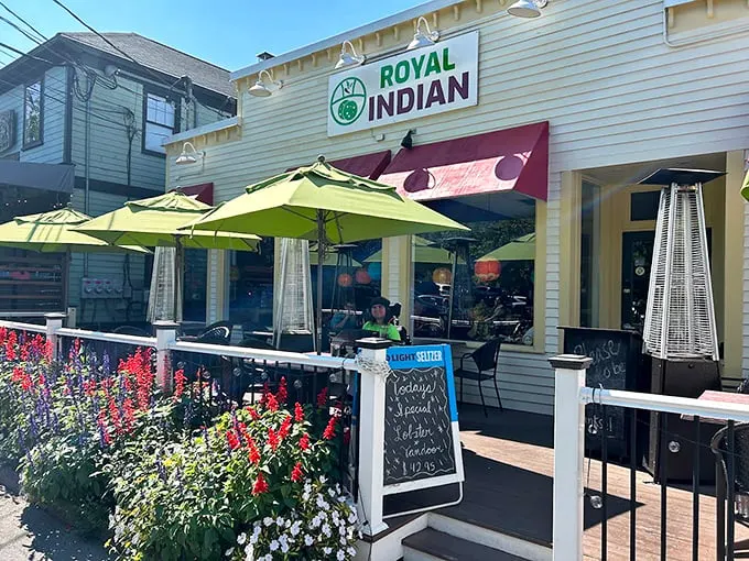 A cheerful yellow exterior with lime-green umbrellas welcomes you like a sunny day in Maine, complete with colorful flowers adding their own spicy pop. Photo credit: William Procko