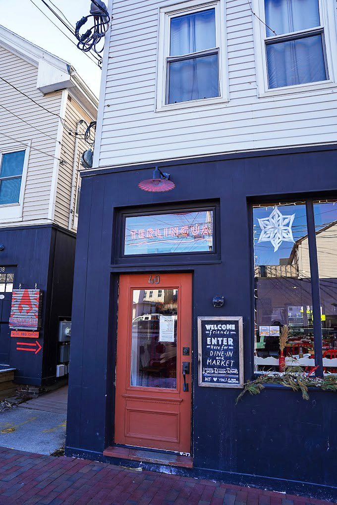 The navy-blue facade and coral door of Terlingua stand like a colorful beacon on Washington Avenue, welcoming hungry souls to BBQ paradise. Photo credit: Benjamin Moore