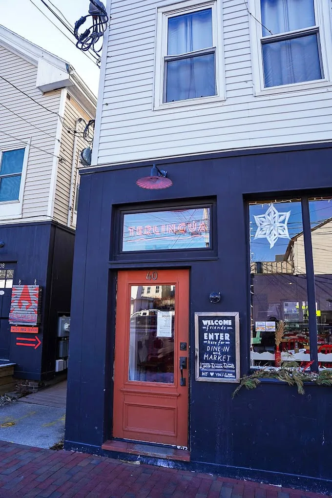 The navy-blue facade and coral door of Terlingua stand like a colorful beacon on Washington Avenue, welcoming hungry souls to BBQ paradise. Photo credit: Benjamin Moore