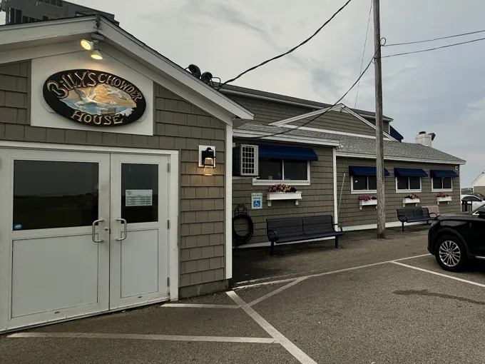 A classic New England seafood shack with weathered shingles and blue awnings, Billy's Chowder House beckons hungry travelers like a coastal lighthouse. Photo credit: The Perfect duo