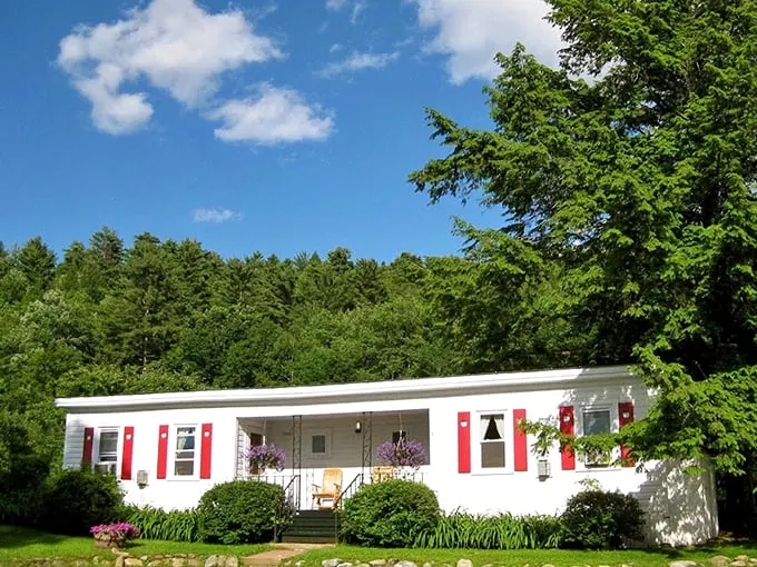Welcome to apple paradise! This charming white farmhouse with cheery red shutters is like a Norman Rockwell painting come to life.
