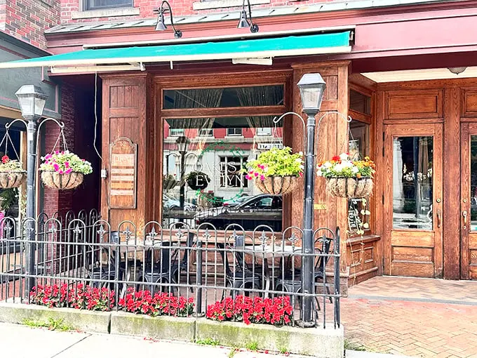 A charming storefront that looks like it was plucked from a Hallmark movie, complete with hanging flower baskets and welcoming wooden details.