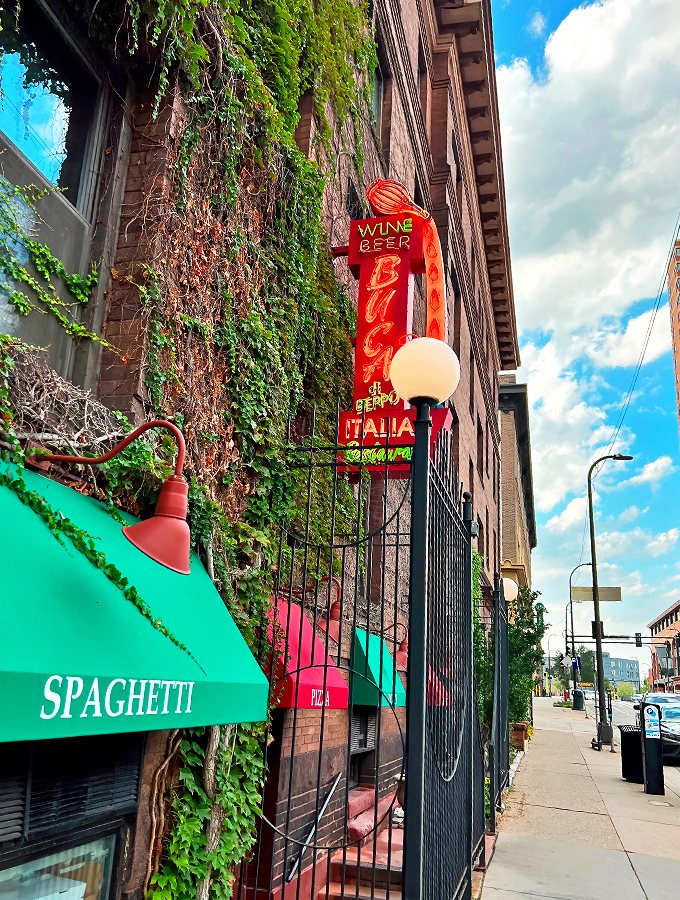 Mama mia! This brick facade isn't just a wall – it's a portal to pasta paradise. Red awnings and ivy whisper promises of cozy Italian feasts within.
