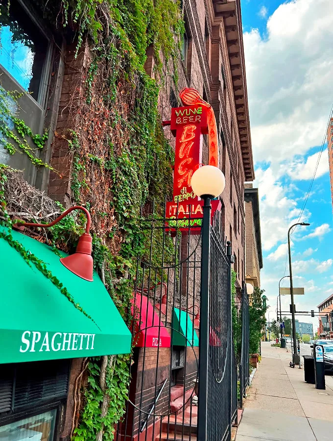 Mama mia! This brick facade isn't just a wall – it's a portal to pasta paradise. Red awnings and ivy whisper promises of cozy Italian feasts within.
