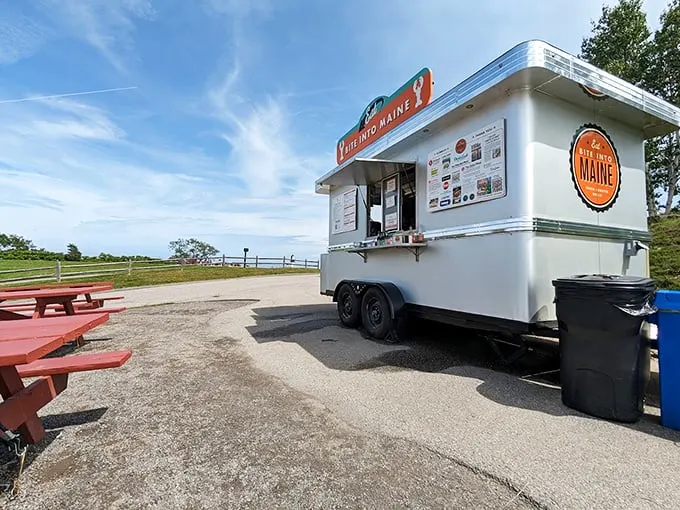 A gleaming white food truck against Maine's blue sky, Bite Into Maine stands ready to serve up happiness on wheels. Photo credit: Elbert Johnson