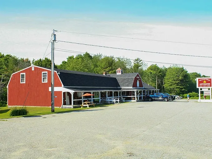 A classic red New England barn transformed into a treasure hunter's paradise. The covered porch welcomes visitors like an old friend's embrace.