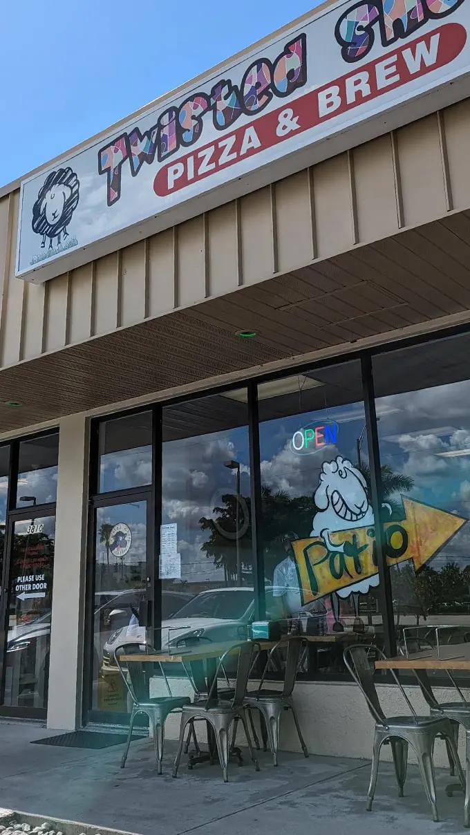 Welcome to Twisted Sheep, where the only thing more inviting than the sign is the aroma wafting from inside. This place is so warm and welcoming, you'll feel like you've been invited to a family reunion – minus the awkward small talk. Photo credit: Bill Palis
