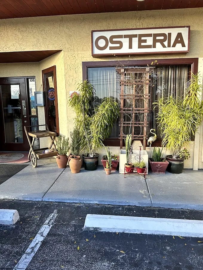 Welcome to Osteria Rustica, where Florida meets Italy! This charming façade is like a portal to Tuscany, complete with potted plants that seem to whisper, "Mangia!"