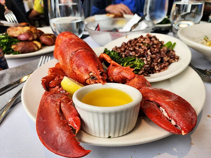This whole Maine lobster isn't just dinner - it's a crimson celebration with drawn butter as liquid gold. Photo credit: Ed P