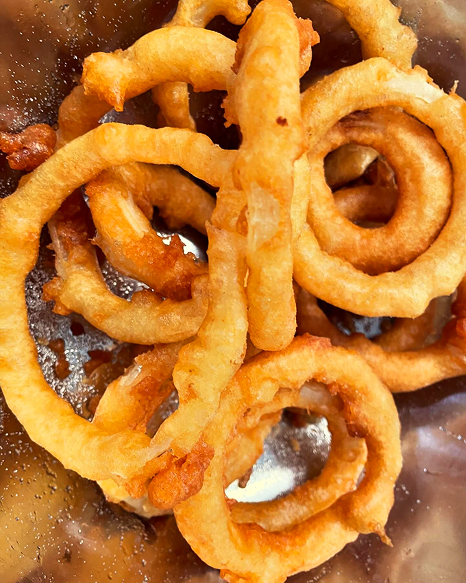 Golden-brown rings of happiness, perfectly crispy and ready for their close-up. These aren't your average onion rings.
