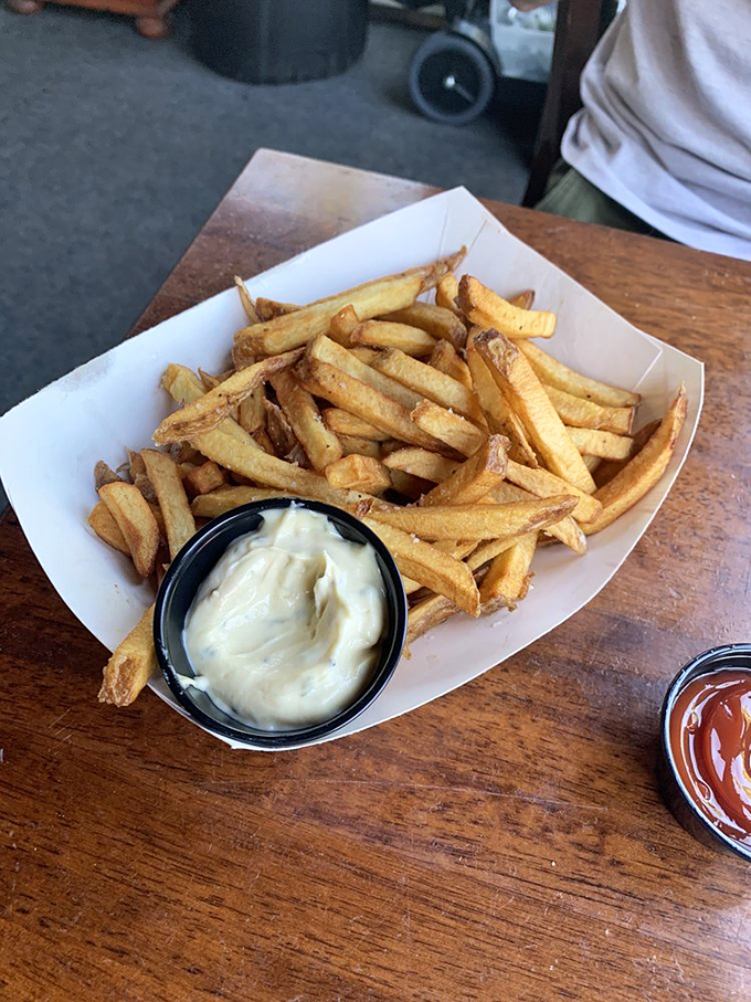 These aren't just fries – they're golden potato perfection, hand-cut and served with creamy house-made aioli. Photo credit: Emily B.