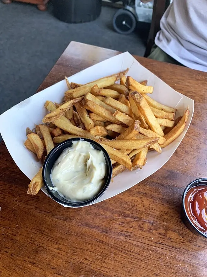 These aren't just fries – they're golden potato perfection, hand-cut and served with creamy house-made aioli. Photo credit: Emily B.