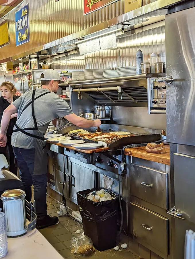 The breakfast ballet in full swing! Watch as short-order cooks pirouette around each other, creating edible masterpieces on the fly.