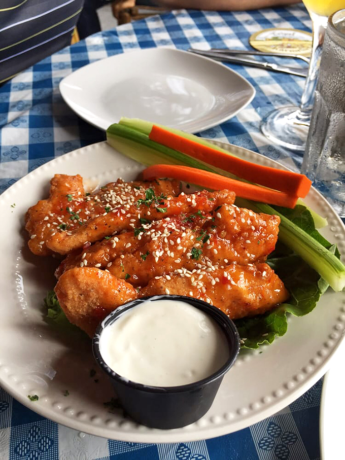Crispy wings glazed with sweet-spicy sauce and sesame seeds, served with fresh vegetables and cooling ranch. Photo credit: Karen S.