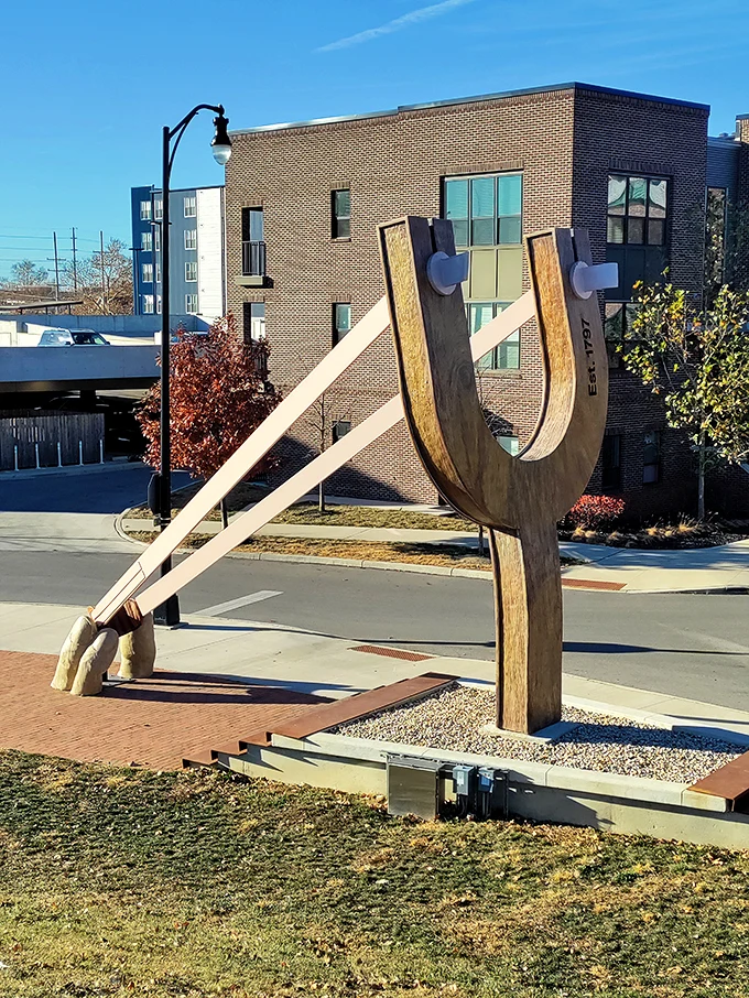 Sun's out, fun's out! On a clear day, this slingshot isn't just an artwork—it's a beacon of joy in a sea of brick and mortar.