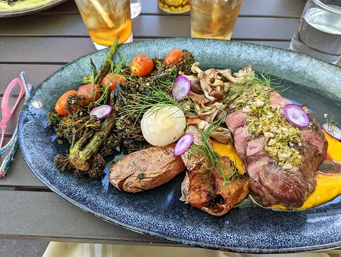 A steak dinner that's dressed to impress, complete with charred vegetables and sauces that mean business.