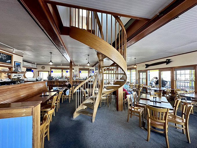 That spiral staircase isn't just functional, it's art. The warm wood and natural light make this dining room feel like a captain's quarters. Photo credit: Sam Santiago