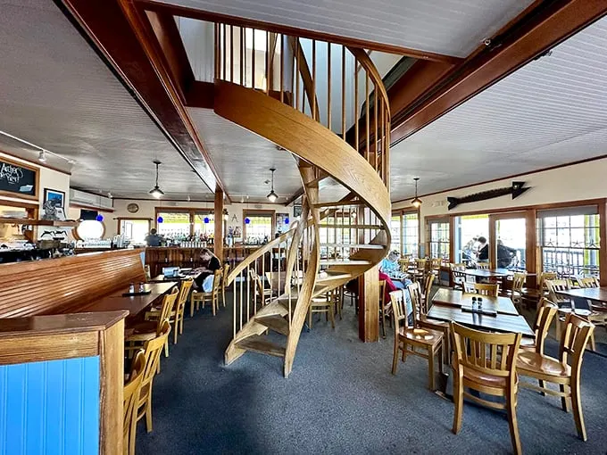 That spiral staircase isn't just functional, it's art. The warm wood and natural light make this dining room feel like a captain's quarters. Photo credit: Sam Santiago