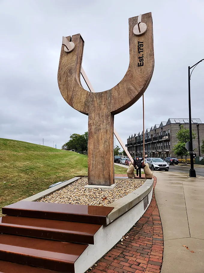 For scale: One giant slingshot, two awestruck humans. It's like a scene from "Honey, I Blew Up the Kid," but with better urban planning.