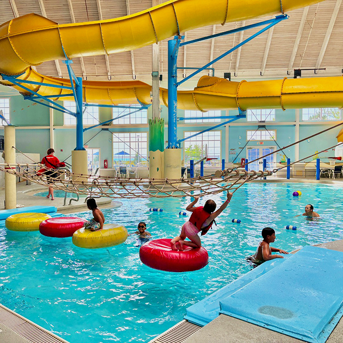 Splashes, laughter, and a little friendly chaos – kids challenge the floating course, dodging wobbling rings and towering water slides above. Photo credit: Blue Harbor Resort & Conference Center