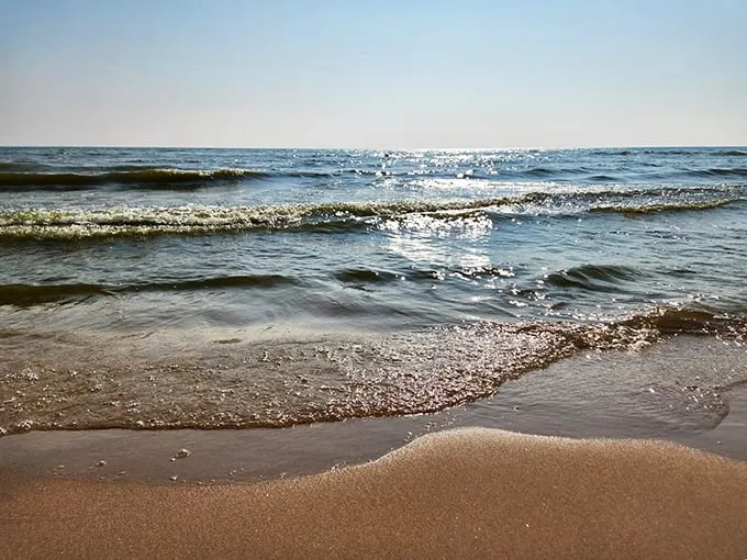 Lake Michigan's crystal waters dance with sunlight, creating a mesmerizing display that rivals any Caribbean postcard.