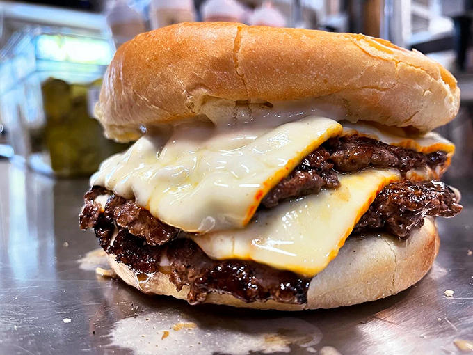 Melty cheese cascades down perfectly charred patties like a waterfall of deliciousness. This is burger architecture at its finest.