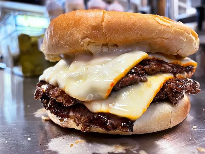 Melty cheese cascades down perfectly charred patties like a waterfall of deliciousness. This is burger architecture at its finest.