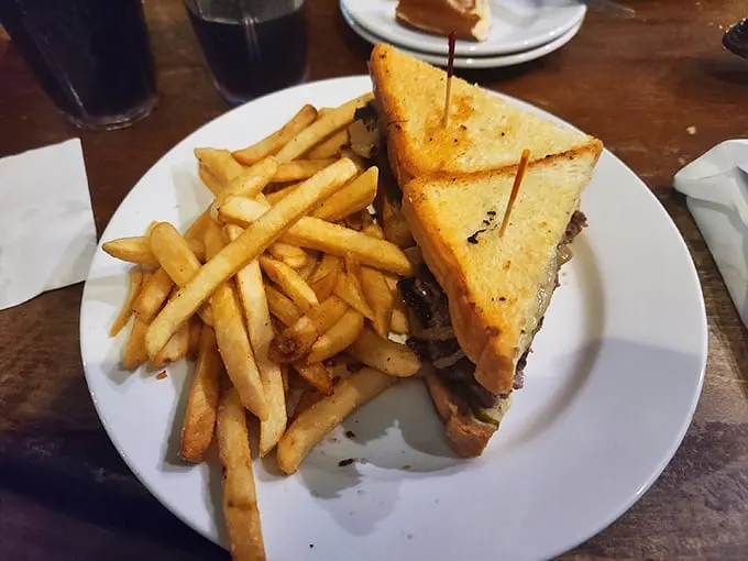 This isn't just a sandwich, it's a flavor explosion. Golden-grilled bread hugs a juicy patty, melty cheese, and crispy fries – comfort food that speaks all languages. Photo credit: Cameron Lennox