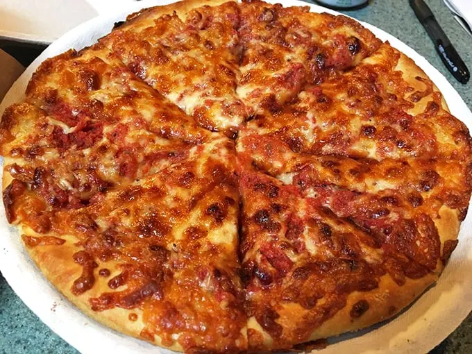 Behold, the holy grail of cheese pulls! This pie could star in its own slow-motion food commercial.