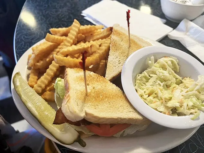 A sandwich that's more stacked than a Jenga tower! This classic diner BLT comes with a side of crispy fries and creamy coleslaw. It's comfort food that hugs your taste buds.