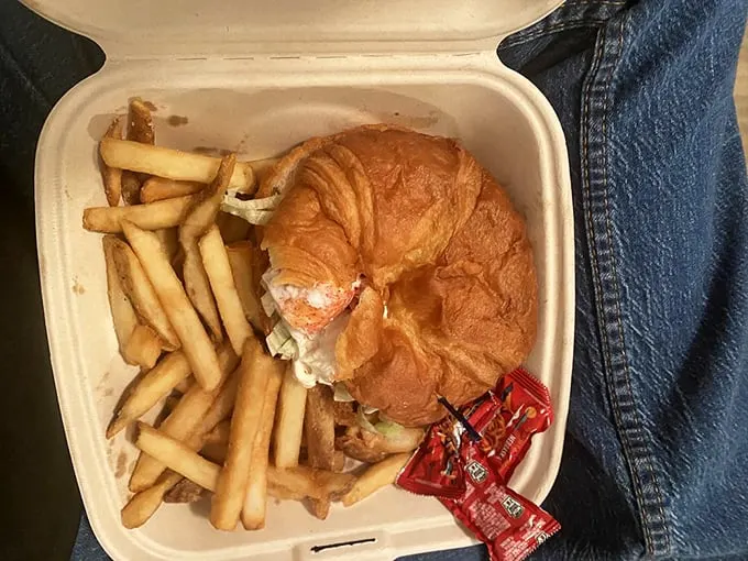 This isn't your ordinary takeout container – it's a treasure chest of fresh lobster nestled in a perfectly golden croissant. Photo credit: Bridget L.