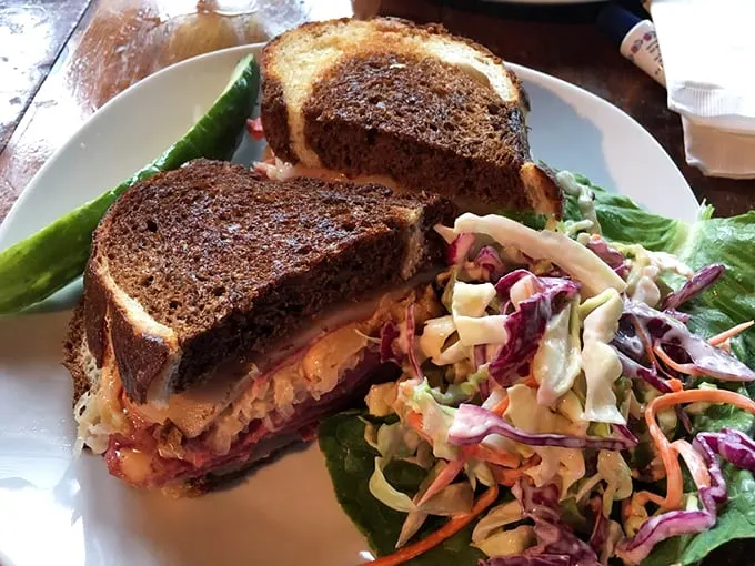 This isn't just a Reuben – it's a towering masterpiece of perfectly marbled corned beef, Swiss cheese, and tangy sauerkraut. Photo credit: Joanna B.