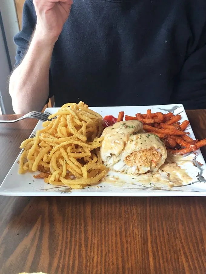 This isn't just dinner, it's edible architecture: Golden onion strings cascade around baked stuffed haddock like a delicious game of Jenga. Photo credit: Donna C.
