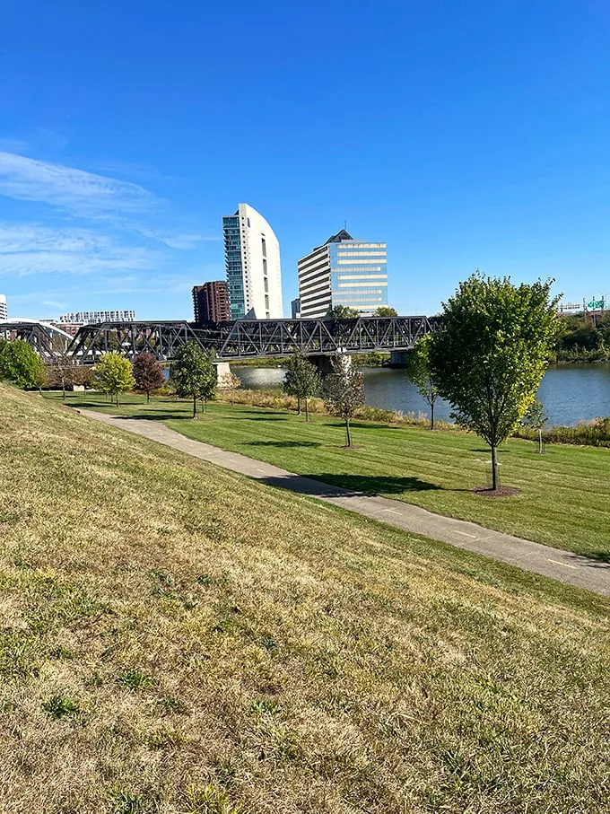 Beyond the slingshot lies Columbus in all its glory. It's like the city is saying, "Sure, we've got skyscrapers, but have you seen our oversized toys?"