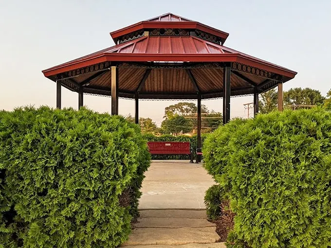 This elegant gazebo, framed by evergreens, stands ready for everything from summer concerts to impromptu picnic shelter duty.