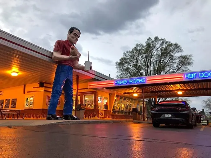 Gus's Drive-In: Where the past is always present. That giant mascot isn't just waving; he's beckoning you to custard paradise!
