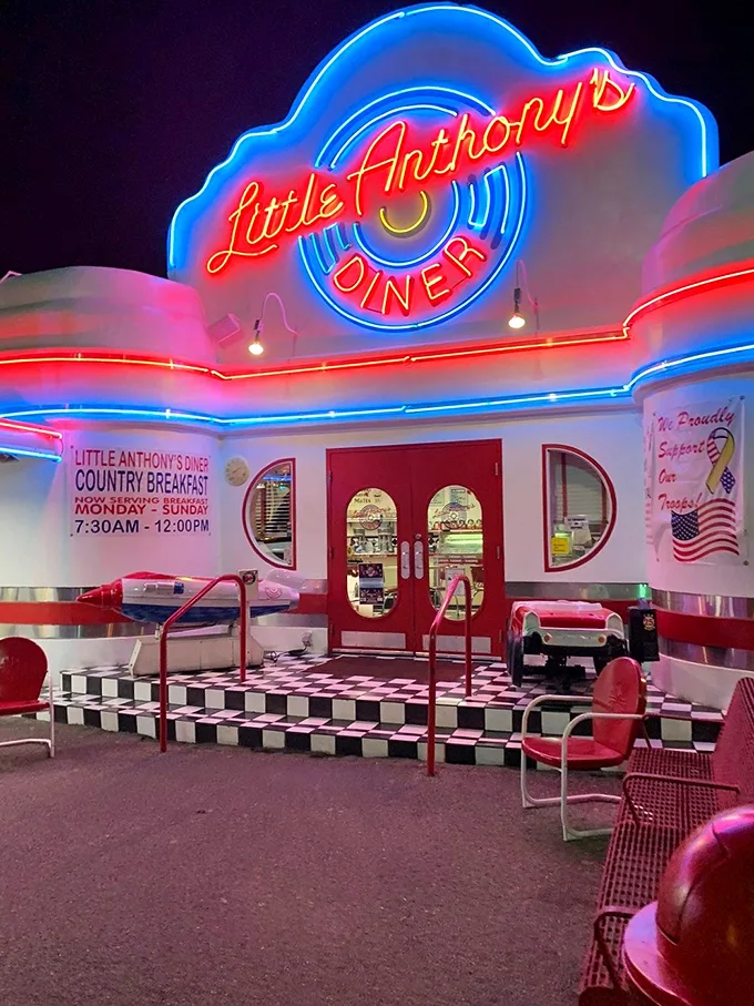 As the sun sets, Little Anthony's neon sign transforms into a beacon of retro cool against the desert twilight.