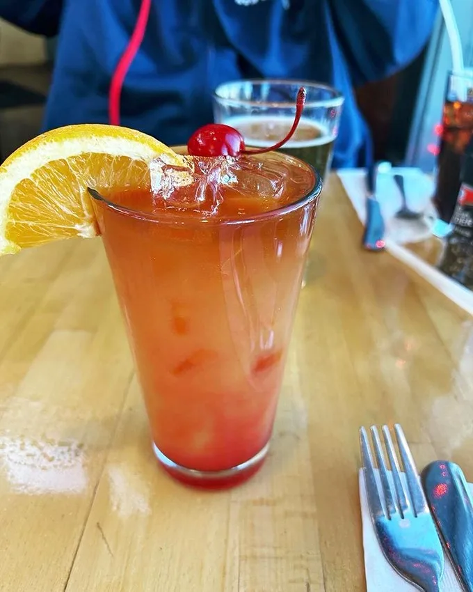 Punch drunk on flavor! This vibrant cocktail is like a liquid postcard from paradise, complete with a cherry on top.
