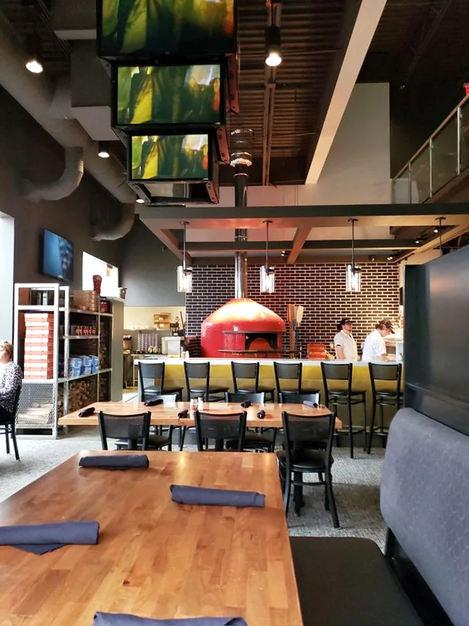 Cozy booths and warm lighting create the perfect atmosphere for your pizza pilgrimage. Let the feast begin!